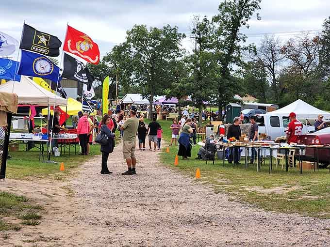 Flags wave overhead as treasure hunters navigate rows of possibilities on this perfect market day.