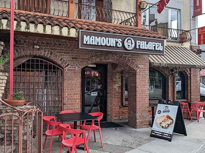That brick archway and glowing sign are basically a portal to falafel heaven on Easton Avenue.
