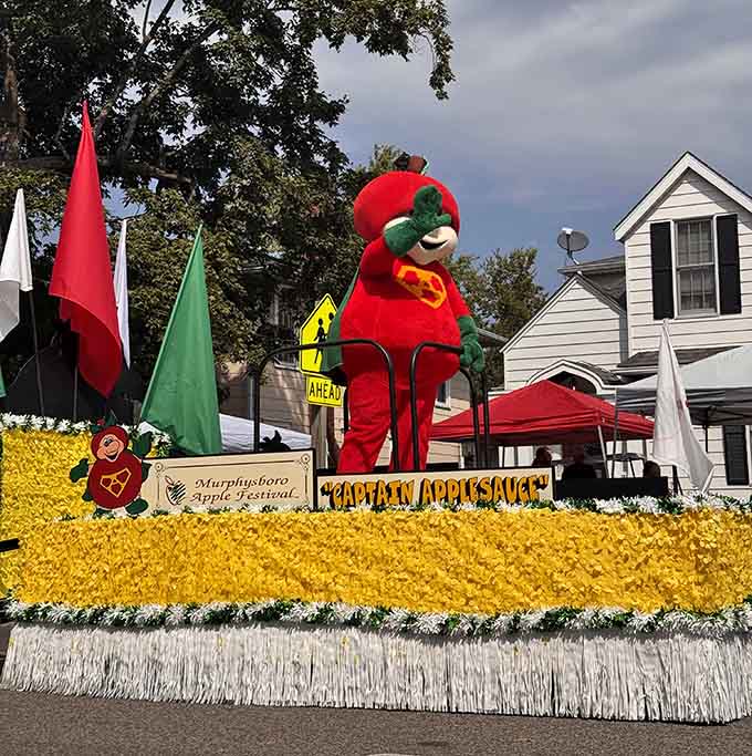 That apple mascot commands the parade float like it owns the place, which honestly, for four days, it does.