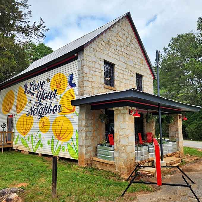 The cheerful "Love Your Neighbor" mural says everything about this place before you even taste the coffee.