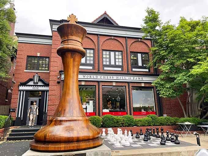 The world's largest king stands guard while regular-sized pieces await their next match on the plaza below.