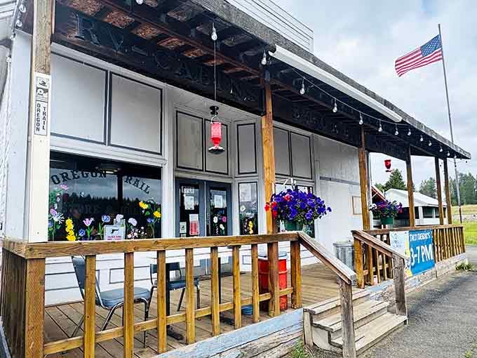 That welcoming front porch with its colorful blooms is your first hint that something wonderfully quirky awaits inside this forest cafe.