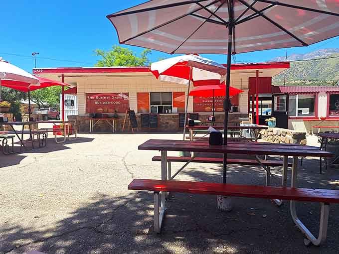 That cheerful red building against the mountain backdrop is your destination for burger bliss and milkshake magic.