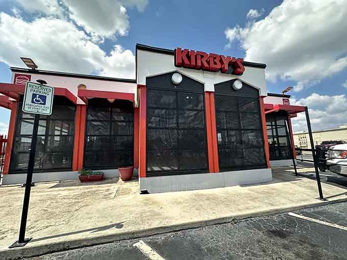 That bold red signage against a perfect Texas sky practically shouts "great burgers live here," and it's not lying.