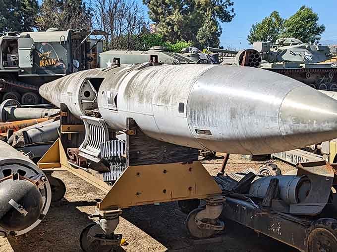 This sleek torpedo resting among vintage military hardware looks like something straight out of a Cold War thriller scene.