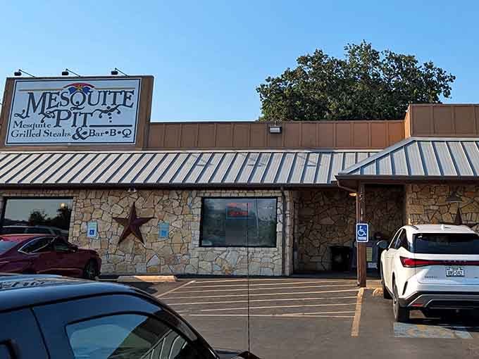 That rustic stone exterior and metal roof whisper "authentic Texas barbecue" louder than any billboard ever could.
