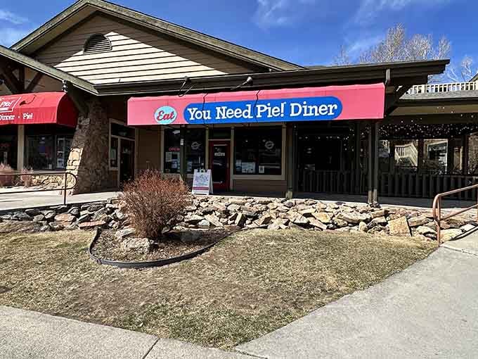 Behind that cheerful awning lies the kind of blueberry pie that makes strangers become believers instantly.