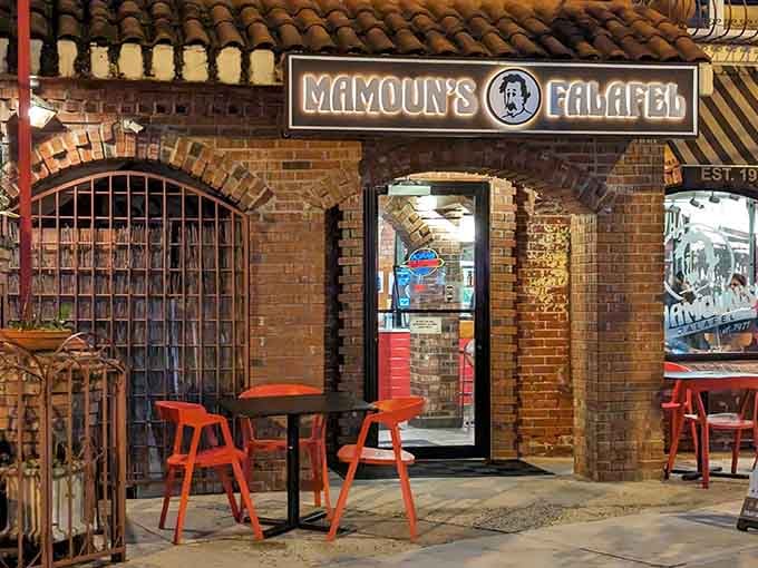 That brick archway and glowing sign are basically a portal to falafel heaven on Easton Avenue.