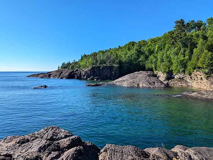 Those dark volcanic rocks meeting that impossibly blue water create a view that'll stop you mid-sentence every time.
