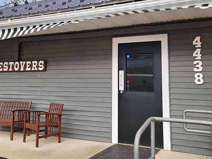 That striped awning and wooden benches whisper "come sit and stay awhile" louder than any neon sign ever could.