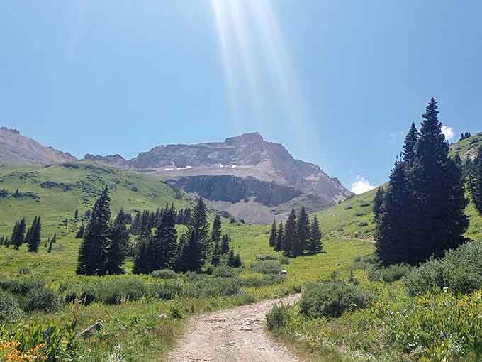 When wildflowers carpet alpine meadows beneath towering peaks, Colorado shows off its most photogenic personality.