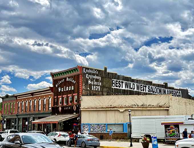 That weathered wooden facade has witnessed more Colorado history than most textbooks could ever capture in words.