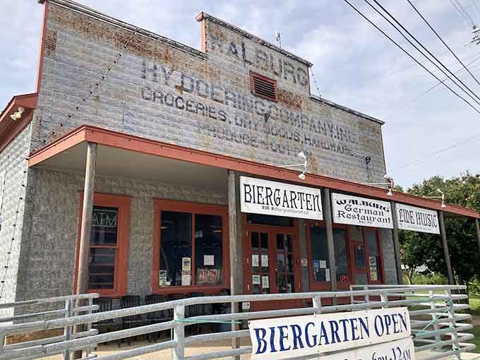 That weathered stone facade and vintage signage aren't just for show &ndash; this is authentic Hill Country history with bratwurst.