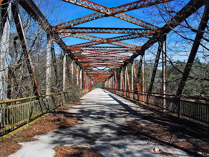 That iconic red bridge stretching across the Suwannee isn't just photogenic, it's your gateway to forgotten Florida history.