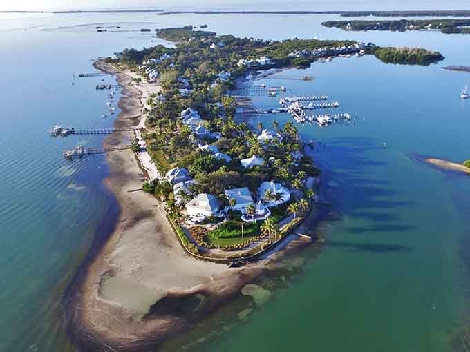 From above, this tiny slice of paradise looks like someone's elaborate daydream made real with turquoise water and swaying palms.