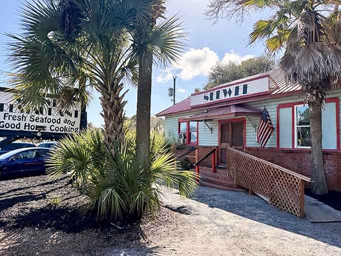 Palm trees and red trim announce you've arrived at seafood paradise along Highway 17.
