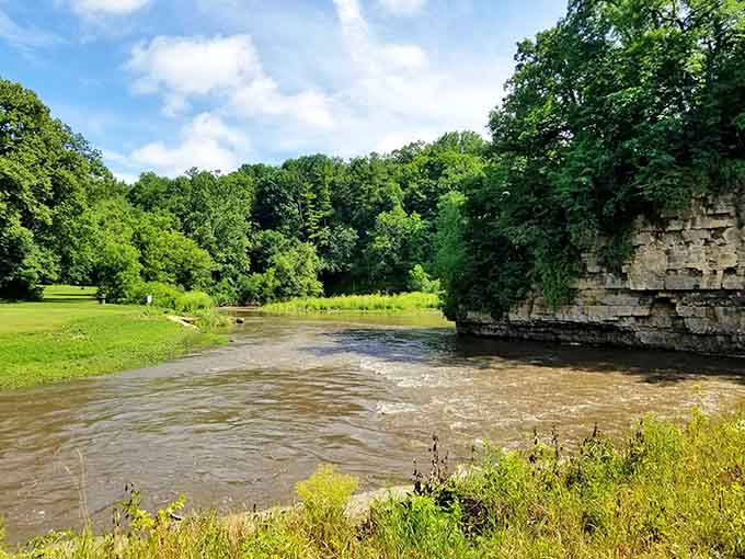 Nature's architecture at its finest, where limestone meets lush greenery in perfect harmony along the water.