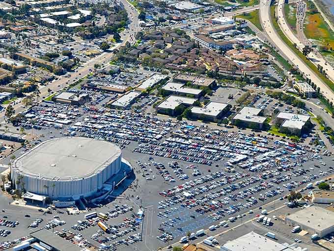 From above, this sprawling marketplace looks like someone spilled a box of matchbox cars across acres of asphalt paradise.