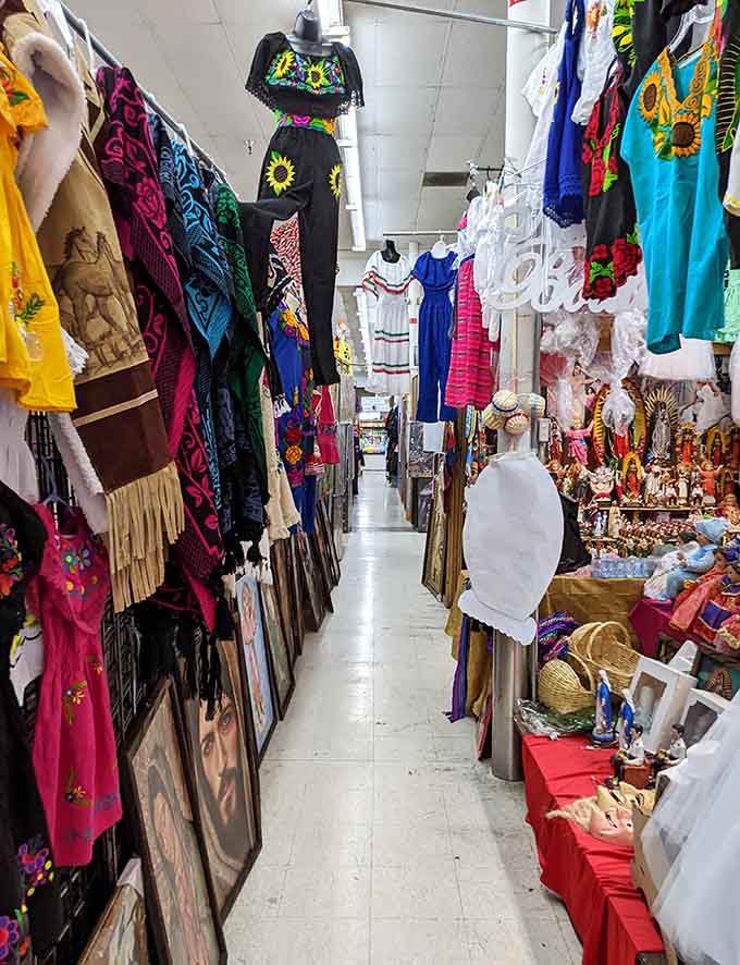 Embroidered dresses and colorful textiles line this corridor like a fashion runway designed by someone who loves maximum visual impact.