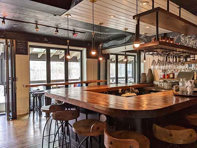 The bar area features warm wood tones and craft cocktails, perfect for pre-dinner drinks or post-work unwinding.