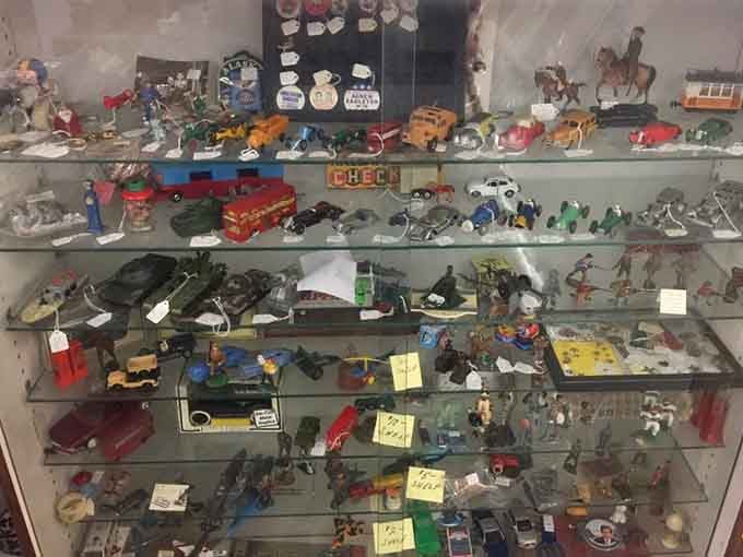 Toy cars and figurines that survived childhood somehow now live safely behind protective glass.
