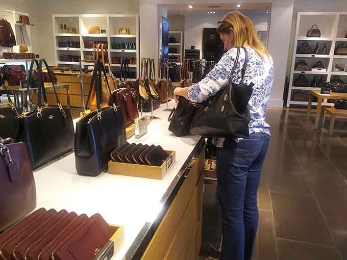 The universal shopping pose: examining a handbag like it holds the secrets to eternal happiness and savings.