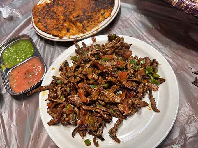Saut&eacute;ed meat with peppers and spices, served alongside flatbread that's practically begging to be used for scooping.