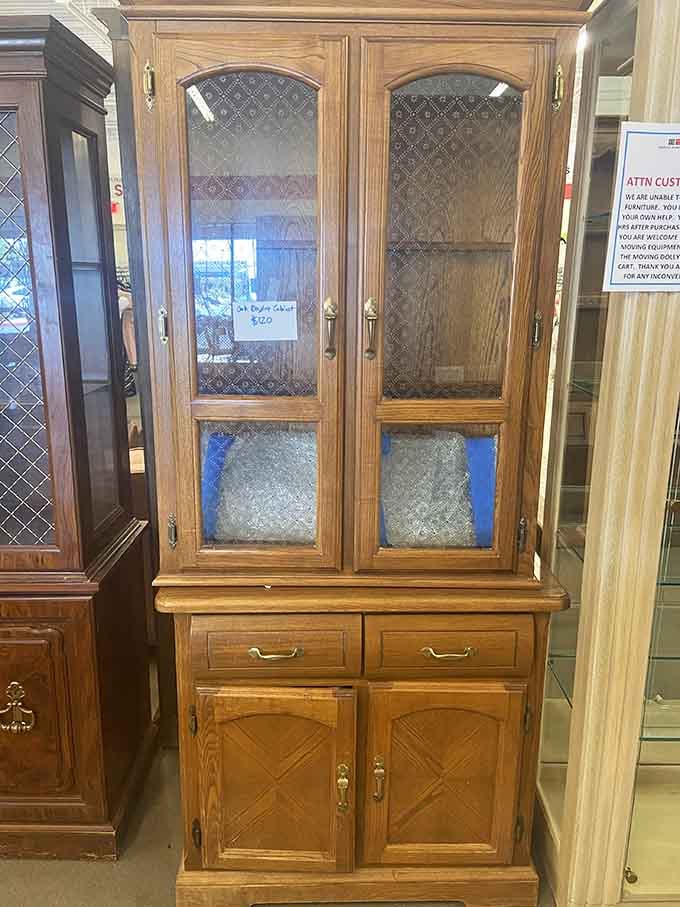 This solid wood china cabinet with textured glass doors belongs in someone's dining room, displaying treasures with vintage charm.