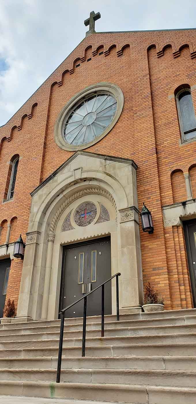 Brick patterns and round windows create architectural poetry on this church facade that's stood watch over the community for generations.