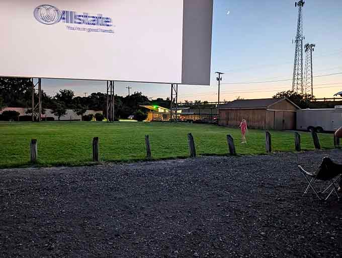 That grassy playground area where kids can burn energy before settling in for the main attraction.