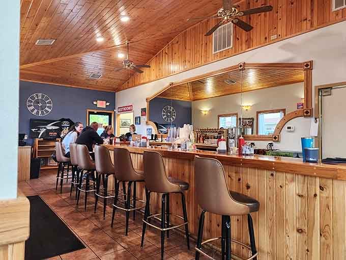 The bar counter with its warm wood paneling offers front-row seats to the breakfast magic happening behind the scenes.