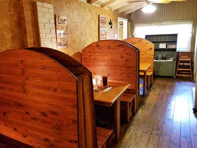 High backed wooden booths offer cozy privacy while inspirational signs remind you that good food feeds the soul too.