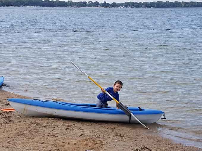 Young adventurers launch kayaks into calm waters, discovering that exploration starts right here in your own backyard.