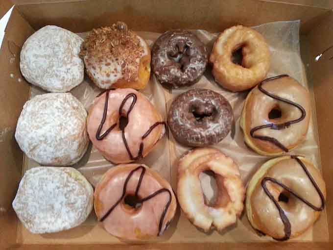 A dozen donuts that barely fit in the box, proving mathematics can be delicious when applied correctly.