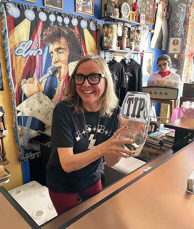 Her smile says it all: working surrounded by this much rock and roll history beats any ordinary office job.