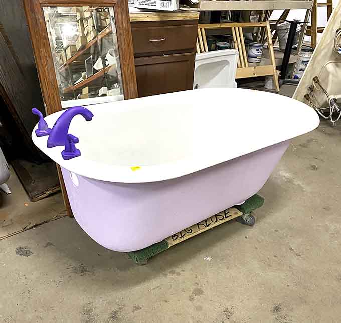 A purple clawfoot tub that's equal parts whimsical and functional, perfect for luxurious bubble bath sessions.