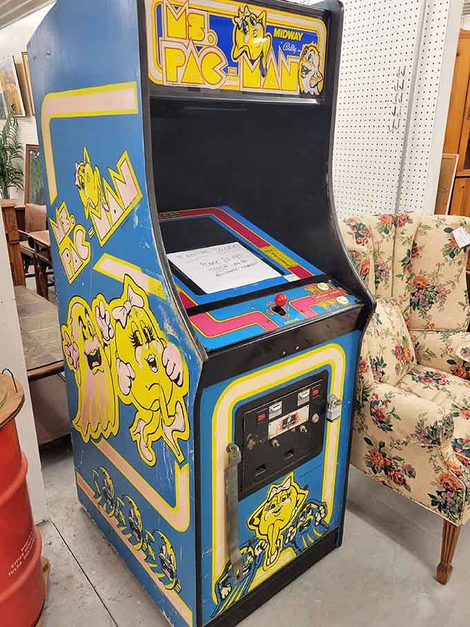 A classic Pac-Man arcade machine stands ready to gobble quarters and transport you back to 1980s glory.
