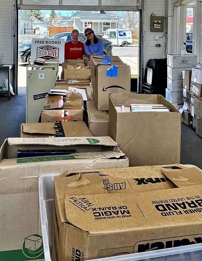 Volunteers surrounded by donation boxes, living proof that some people's trash truly becomes community treasure and literary gold.