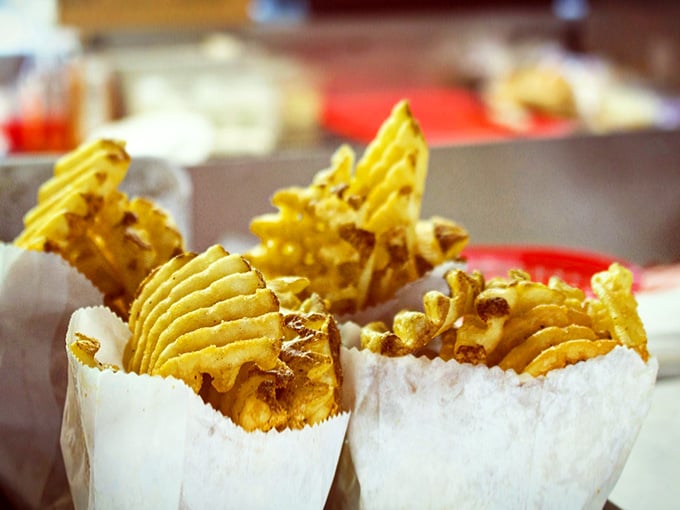 Waffle fries standing at attention, seasoned and ready to disappear faster than you can say pass the ketchup.