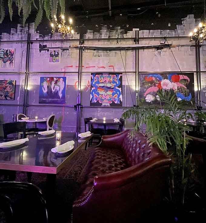 Purple lighting and vibrant artwork create an atmosphere that's part gallery, part dinner party, all fun.