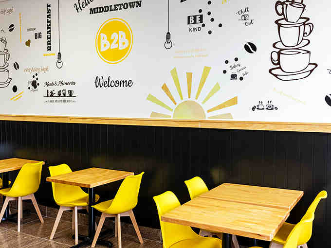 That sunrise mural perfectly captures the feeling of walking in here before you've had your coffee yet.