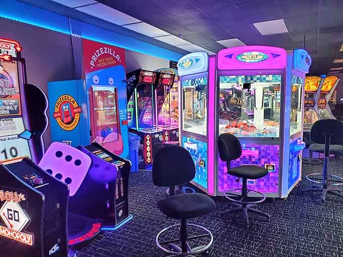Claw machines line up like a colorful jury, each one silently judging your hand-eye coordination and determination levels.