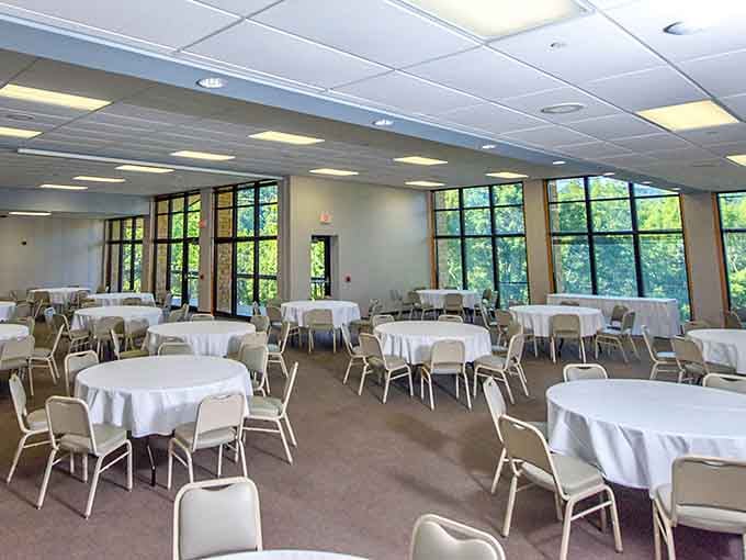 Windows framing forest views, white tablecloths ready for gatherings, this is where celebrations feel genuinely special and memorable.