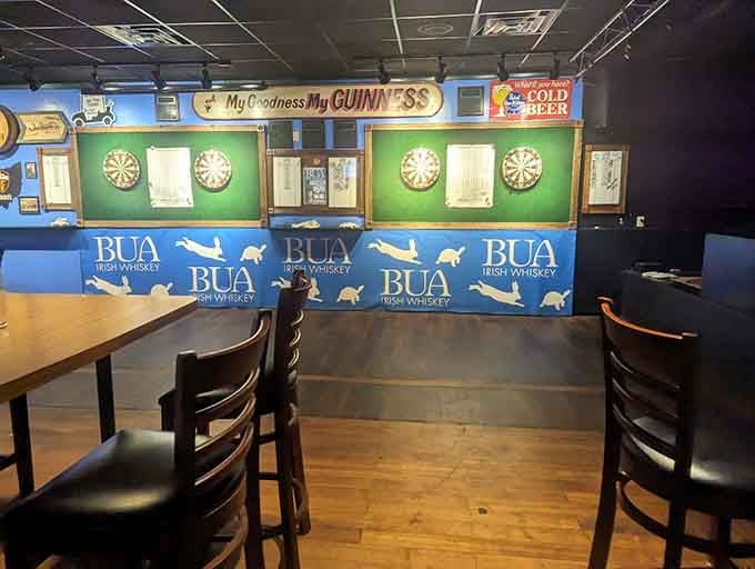 Four dartboards lined up under Guinness signs, where friendly competition and cold beer create the perfect evening.