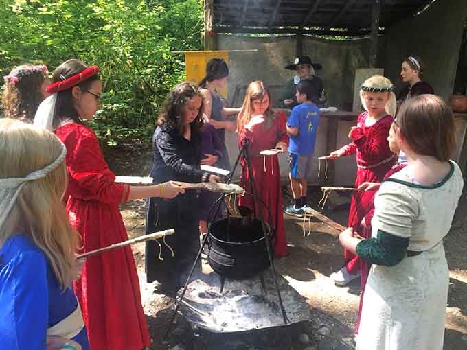 Candle-making demonstrations remind us that medieval evenings were darker than a movie theater during previews.