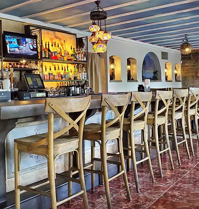 The bar area glows with colorful mosaic lanterns, creating an inviting spot for pre-dinner drinks or post-meal relaxation.