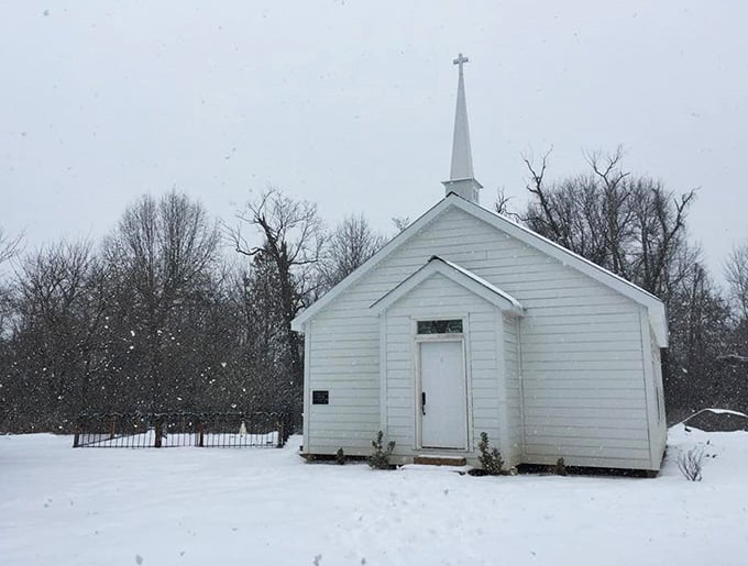 This pristine white chapel in winter looks like a Christmas card designed by someone who really understood frontier faith.