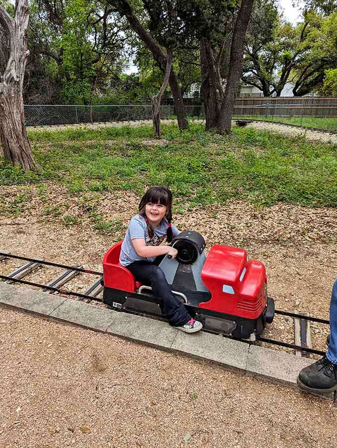 That grin says it all: pure joy on rails, no assembly required, batteries definitely not included.