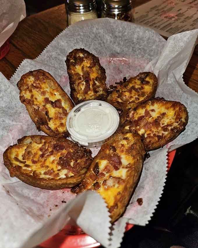 Loaded potato skins topped with cheese and bacon, proving that comfort food will never go out of style here.