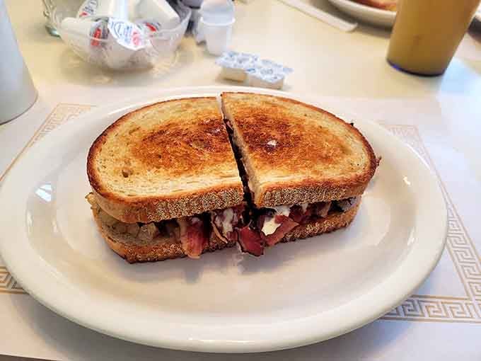 Grilled rye bread hugging corned beef and melted cheese creates the kind of sandwich that demands your attention.